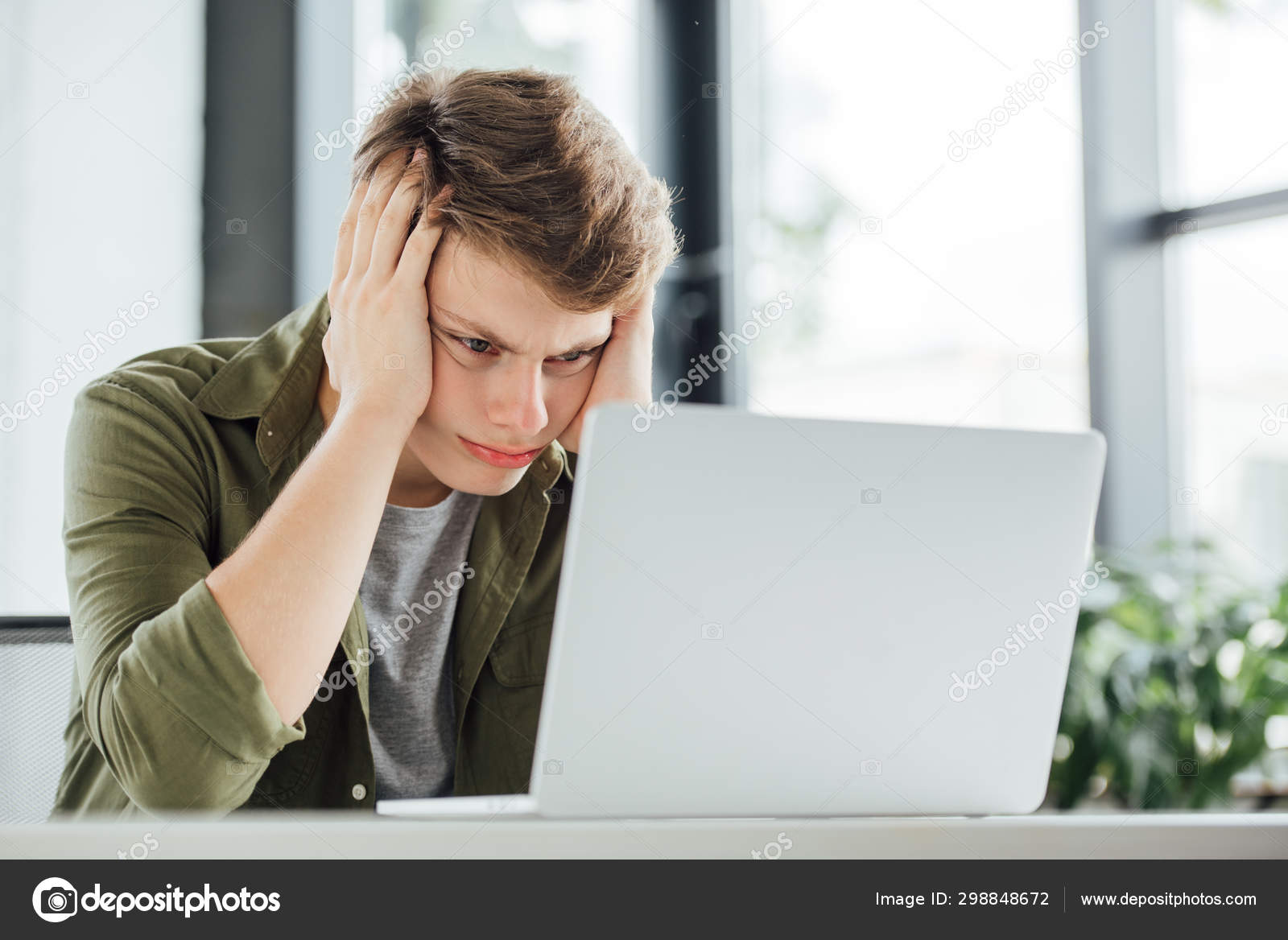 Focused Teen Boy Sitting Table Using Laptop Home Stock Photo by ...