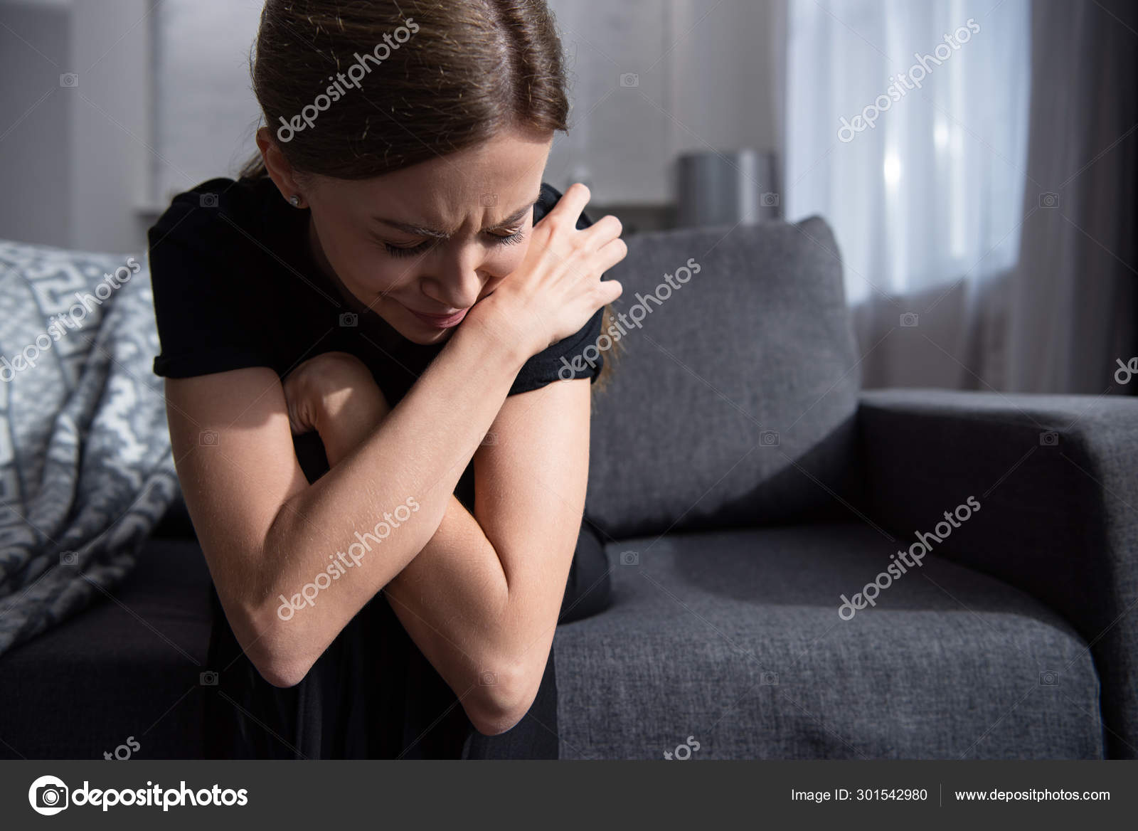 Upset Woman Sitting Sofa Crying Home — Stock Photo © HayDmitriy #301542980