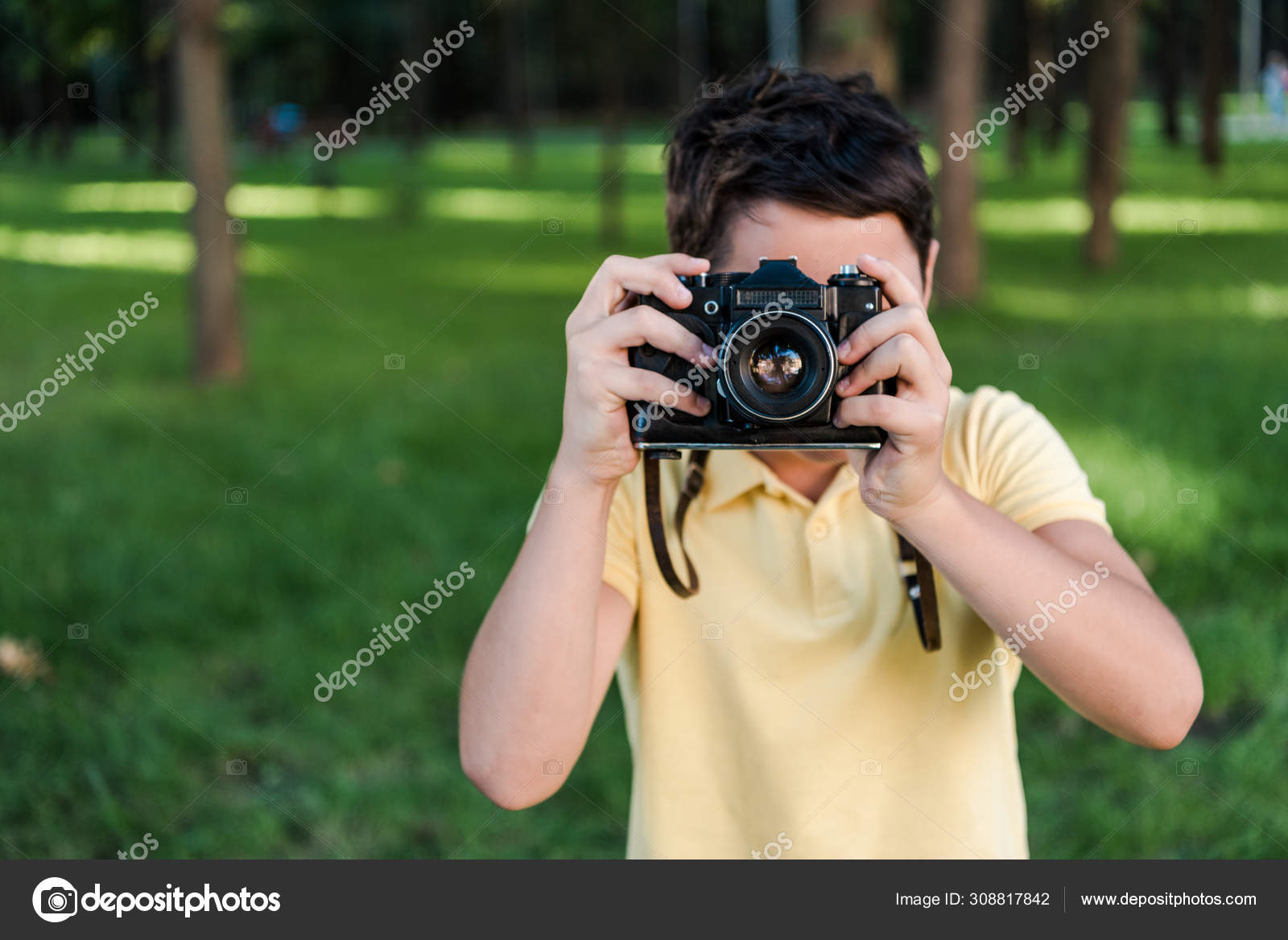 Cute Boy Holding Digital Camera While Talking Photo Park — Stock Photo ...