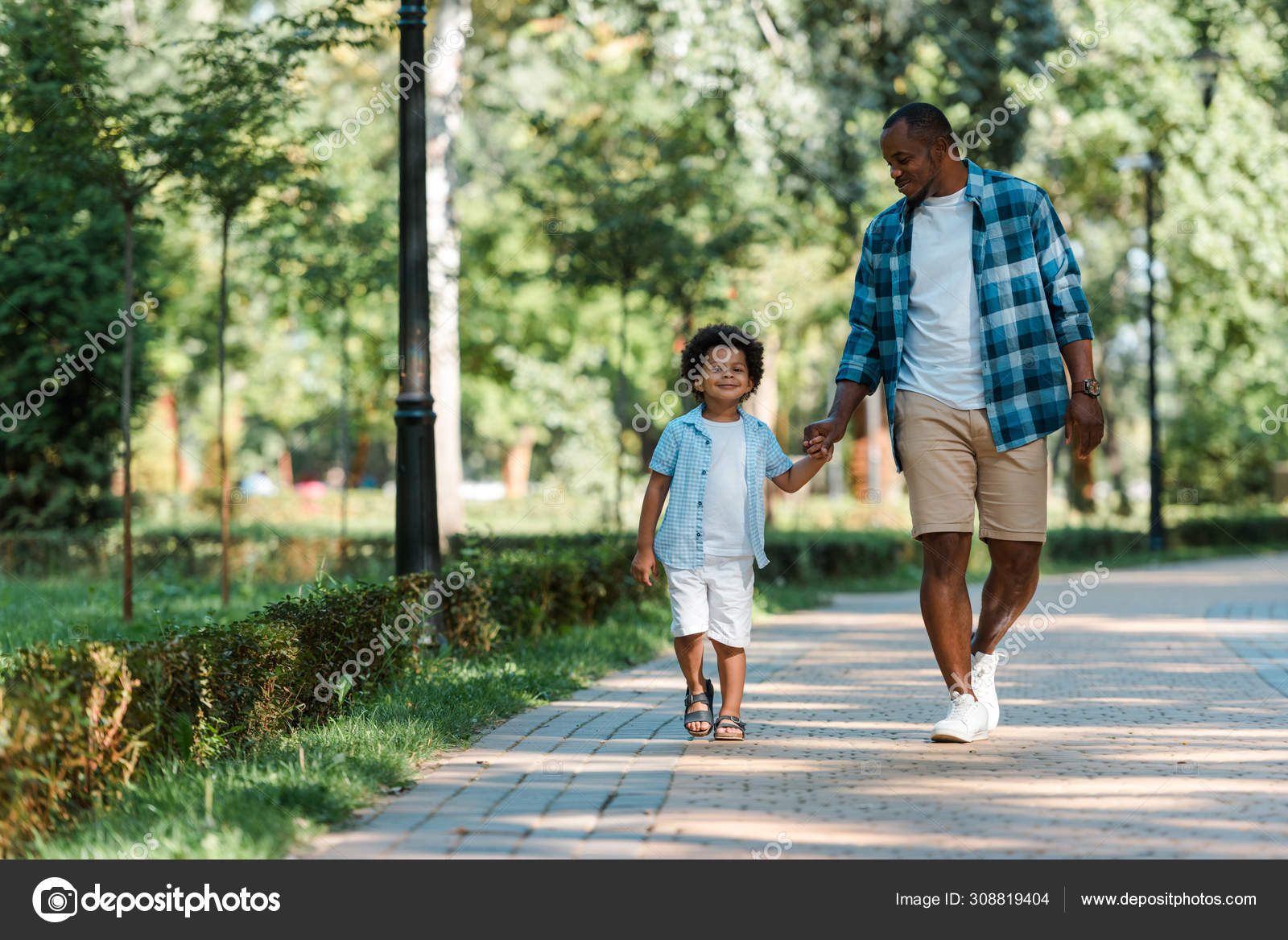 Happy African American Boy Holding Hands While Walking Father — Stock ...