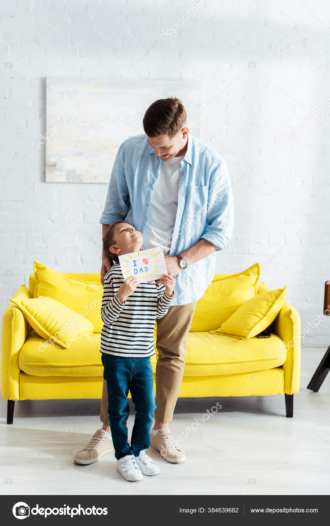 Adorable Boy Looking Father While Holding Handmade Fathers Day Greeting ...