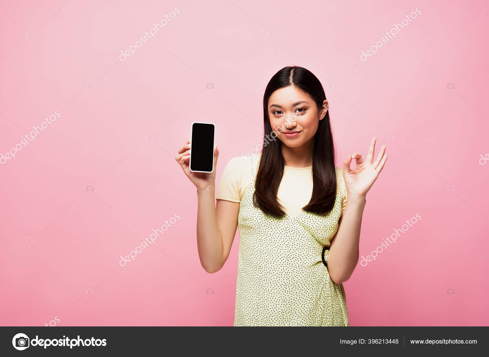 Young Asian Woman Showing Sign While Holding Smartphone Blank Screen ...