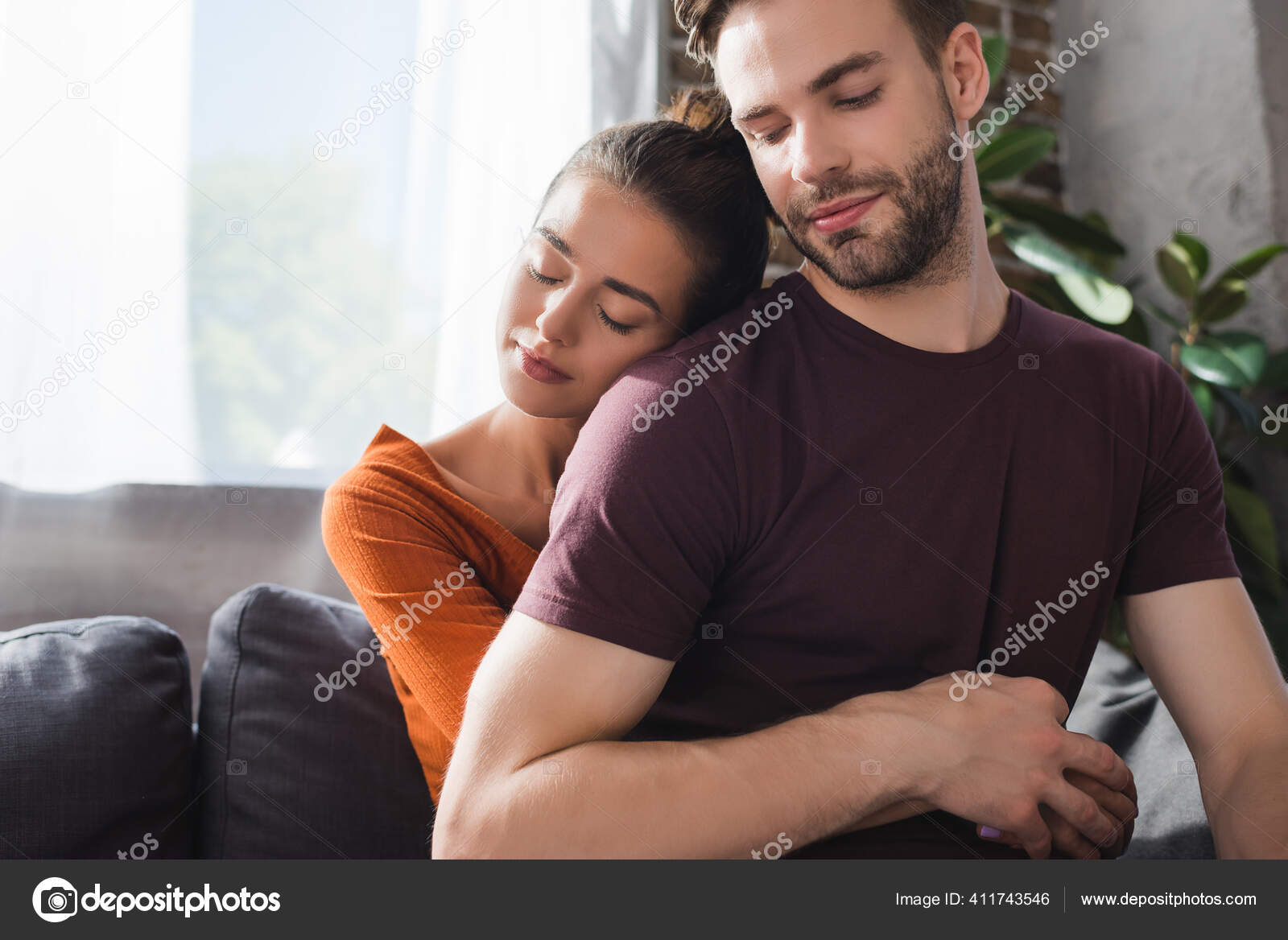 Tender Woman Closed Eyes Embracing Beloved Man Back While Sitting Stock