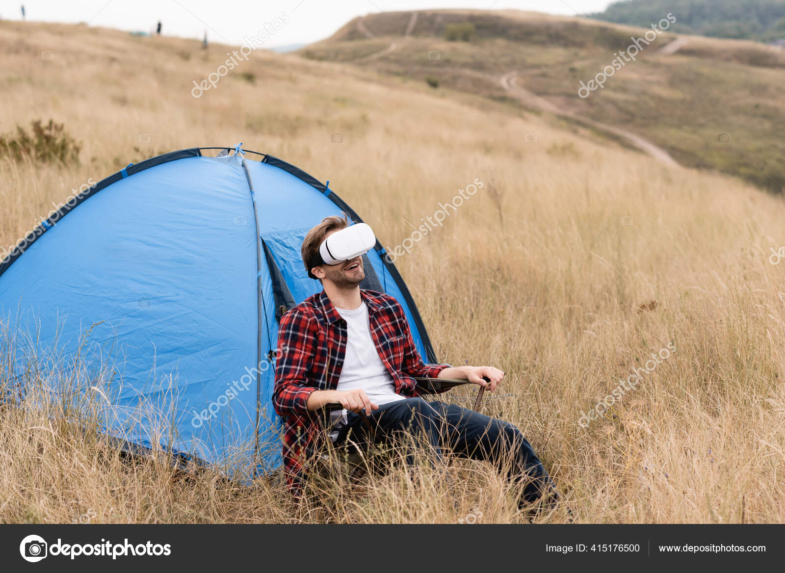 Smiling Man Using Headset While Sitting Tent Lawn — Stock Photo ...