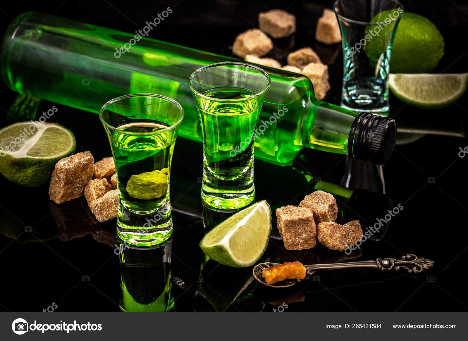 Absinthe shots with sugar cubes and lime isolated on black background ...