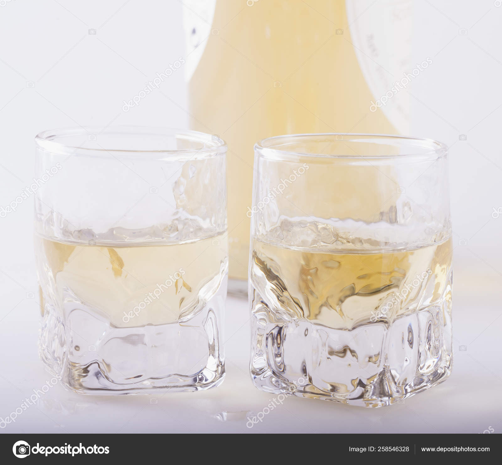 Two Shots Whisky Bottle Background Stock Photo by ©YAYImages 258546328