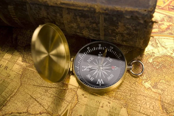 Compass on old map Stock Photo by ©kwanchaidp 78667600