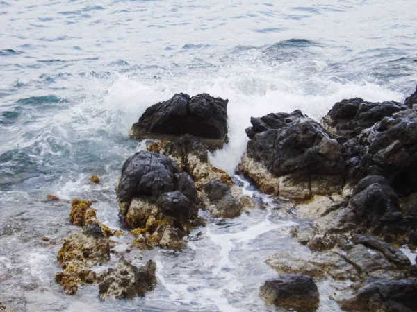 Waves of sea water hitting a rock on the coast of crete shaping the ...