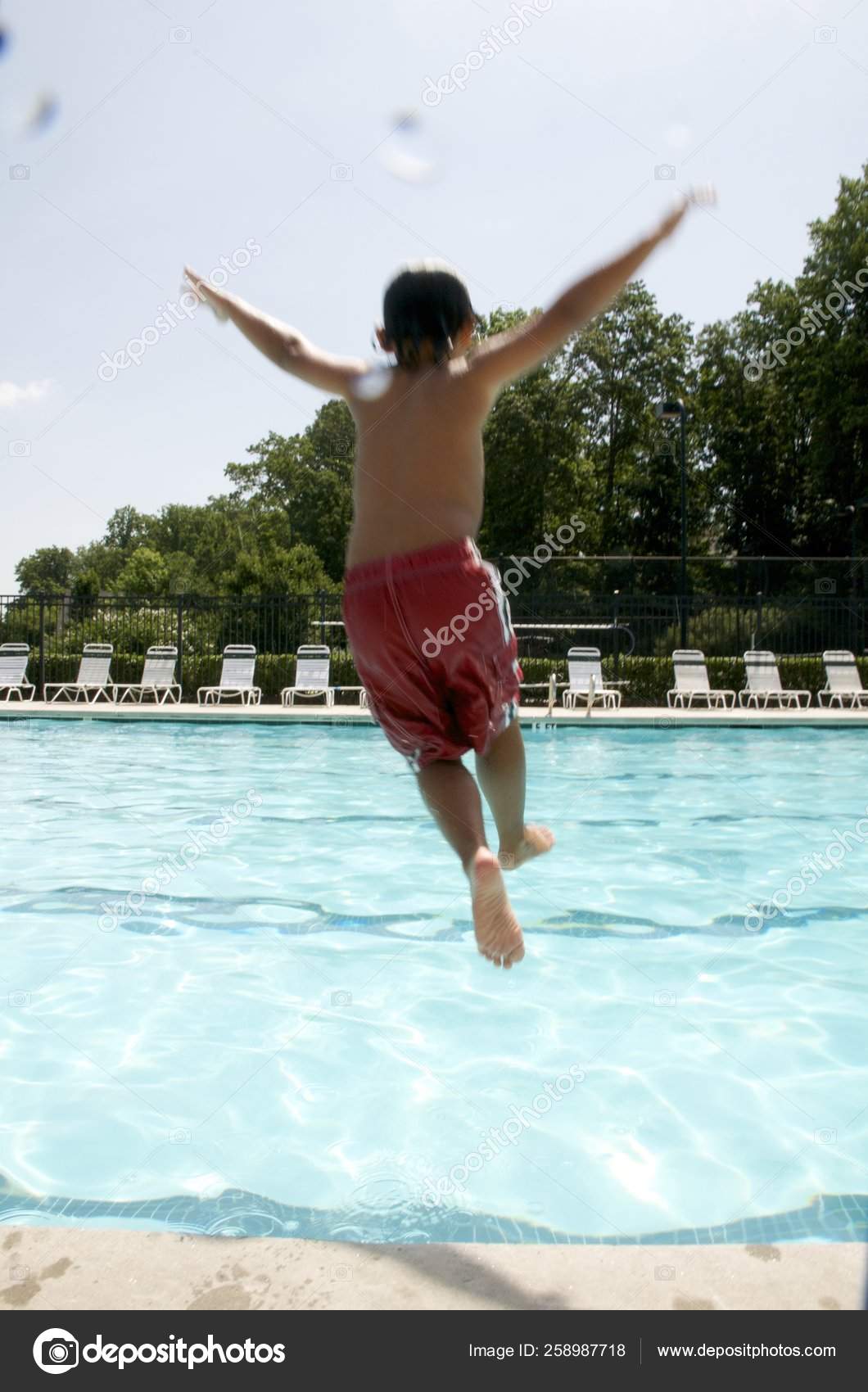 Little Boy Jumping Pool Stock Photo by ©YAYImages 258987718