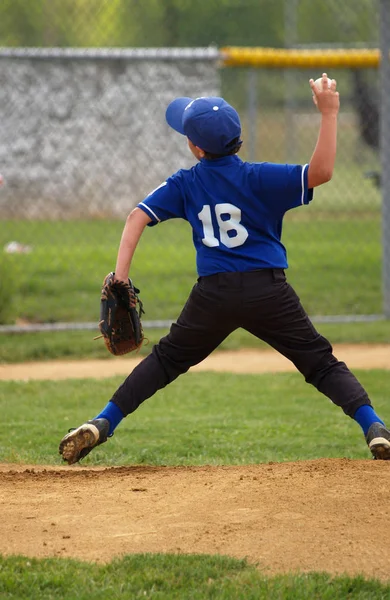 little league baseball pitcher throwing the ball from the mound - Stock ...