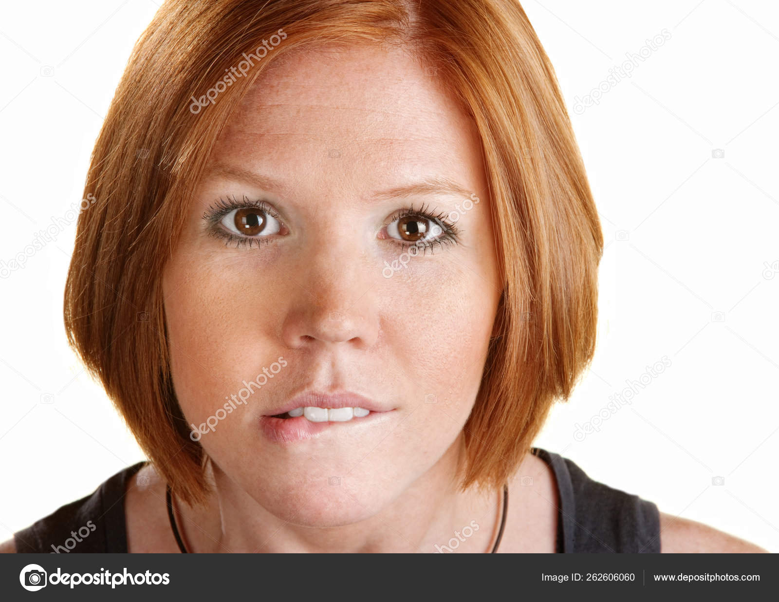 Young Woman Staring Ahead Biting Her Lip Stock Photo by ©YAYImages ...