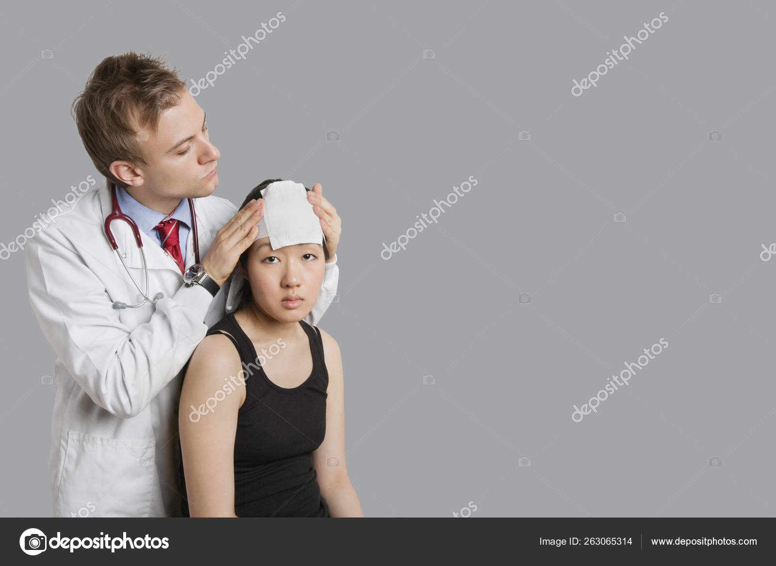 Doctor Adjusting Bandage Patient's Head Stock Photo by ©YAYImages 263065314