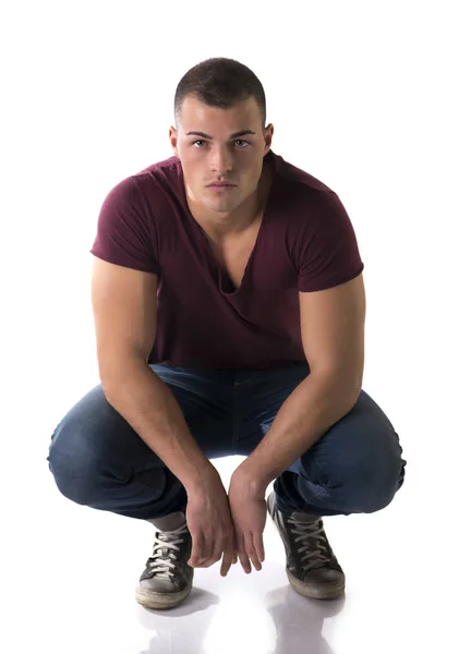 Handsome male bouncer squatting position Stock Photo by ©stockyimages ...