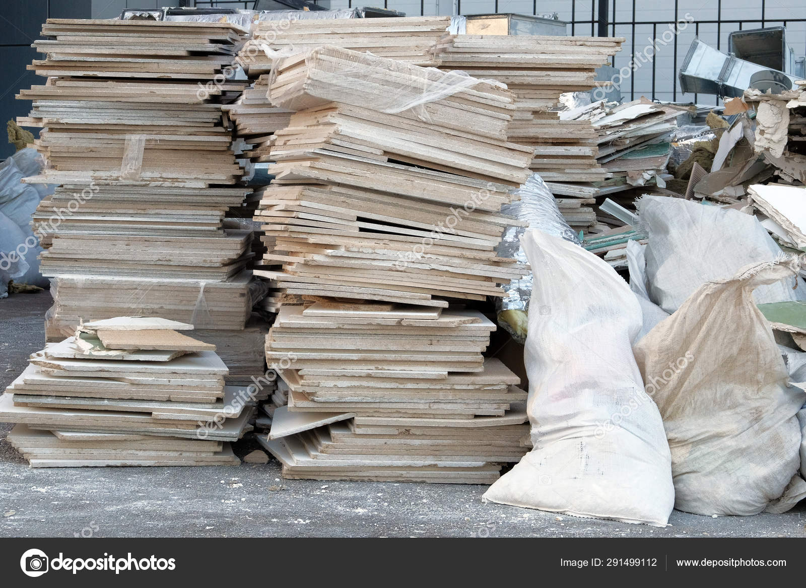 Construction debris in white bags prepared for disposal in a landfill ...