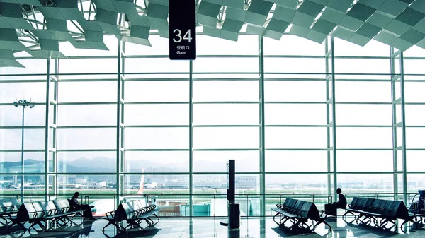 airport terminal interior with seats and boarding pass - Stock Image ...