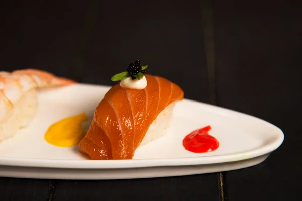 Japanese Nigiri Sake Sushi with marinated salmon, flying fish roe ...