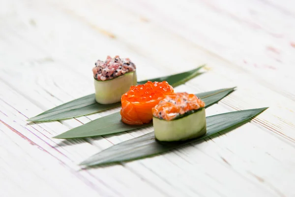 Set of Japanese Gunkan Maki Sushi Rolls: Sake with salmon caviar, tuna Maguro and salmon in ...
