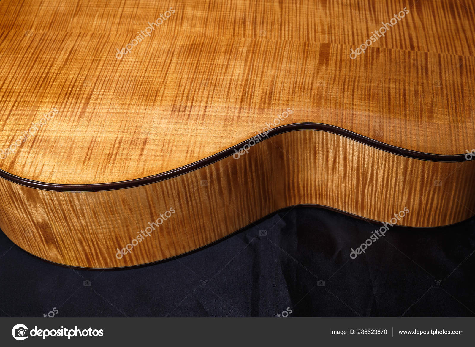 Wood texture of lower deck of six strings acoustic guitar on black ...