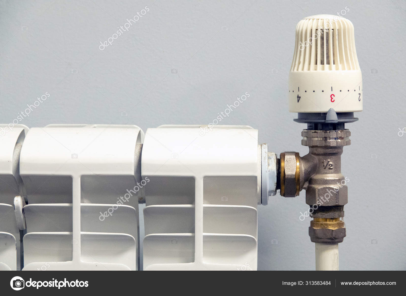 Thermostatic valve on a radiator on gray background Stock Photo by ...
