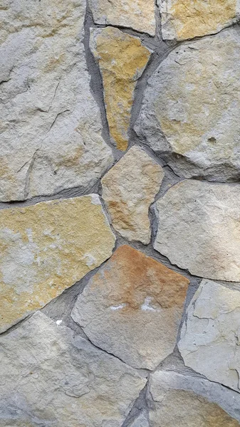 Natural stone. The wall is made of natural sandstone. Stone trim ...