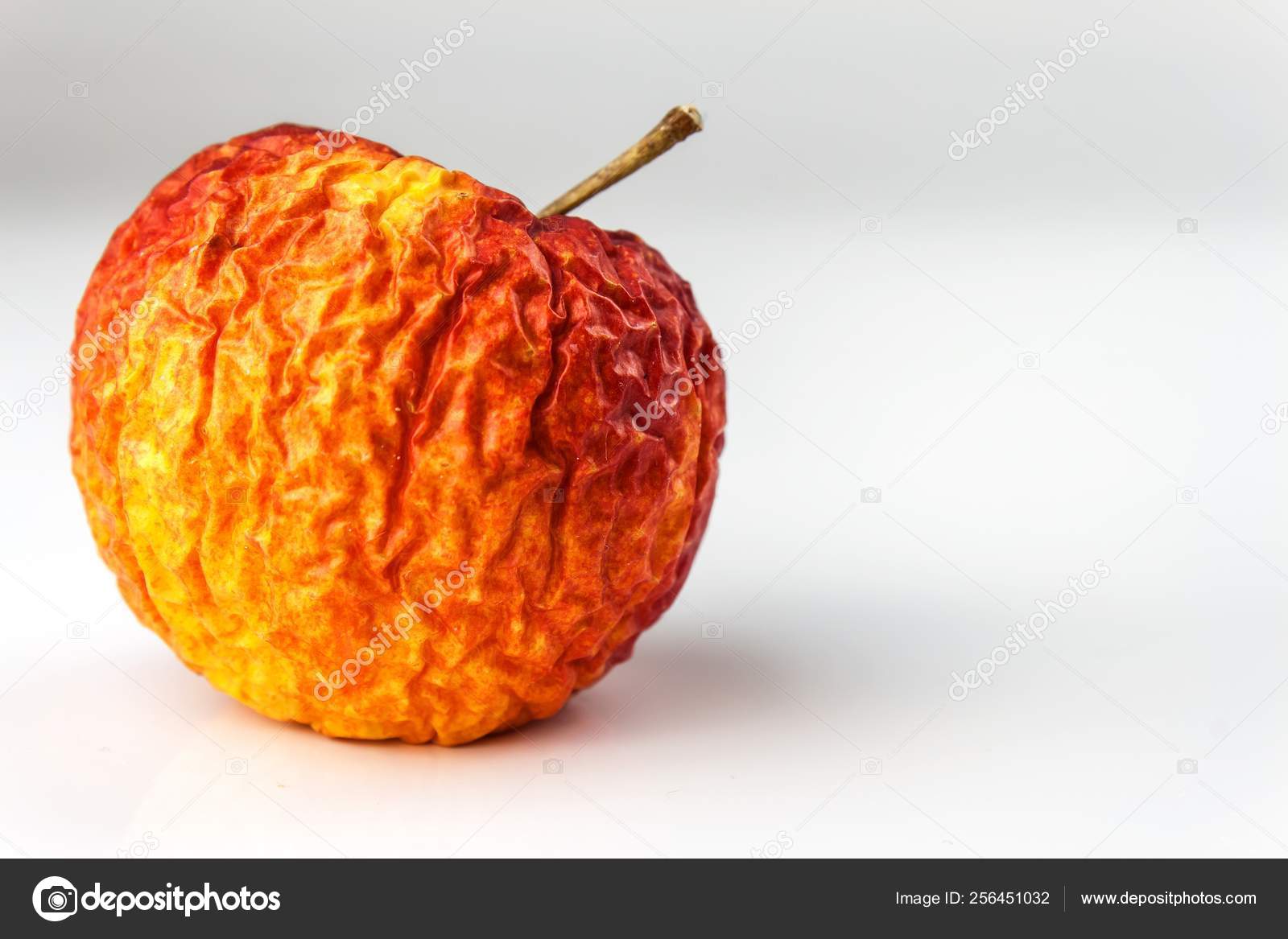 Wrinkled apple texture with white background. Shriveled apple. Old ...