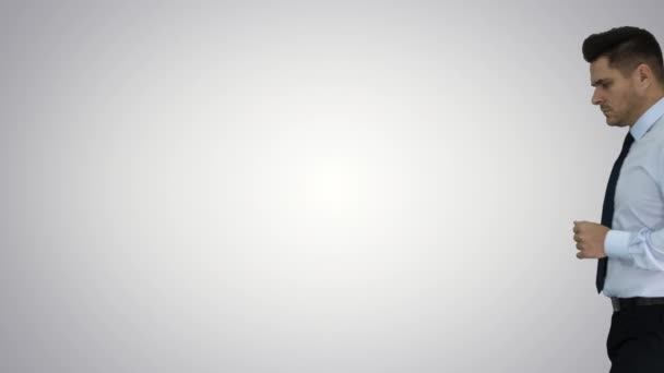 Formal man walks in frame and gets an idea then walks out on gradient ...