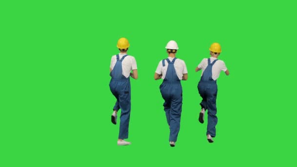Three male construction workers in hard hats synch dancing with their ...