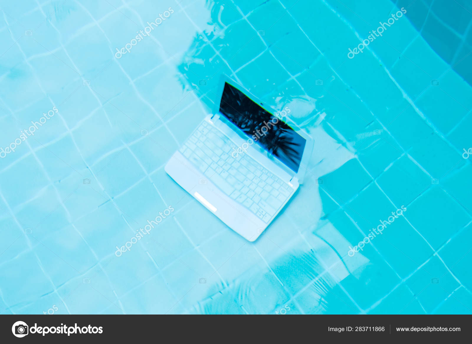 Laptop under water. Minicomputer at the bottom of the pool. The concept ...