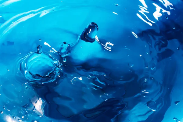 Drop of water. Blue water drop. Falling water. Water splash clos ...