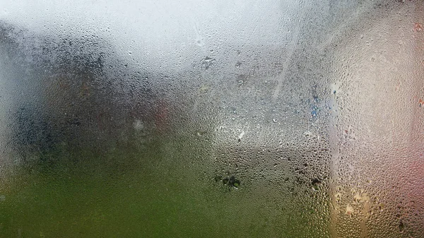 Texture of a fogged window. The first frosts, moisture condenses on the ...