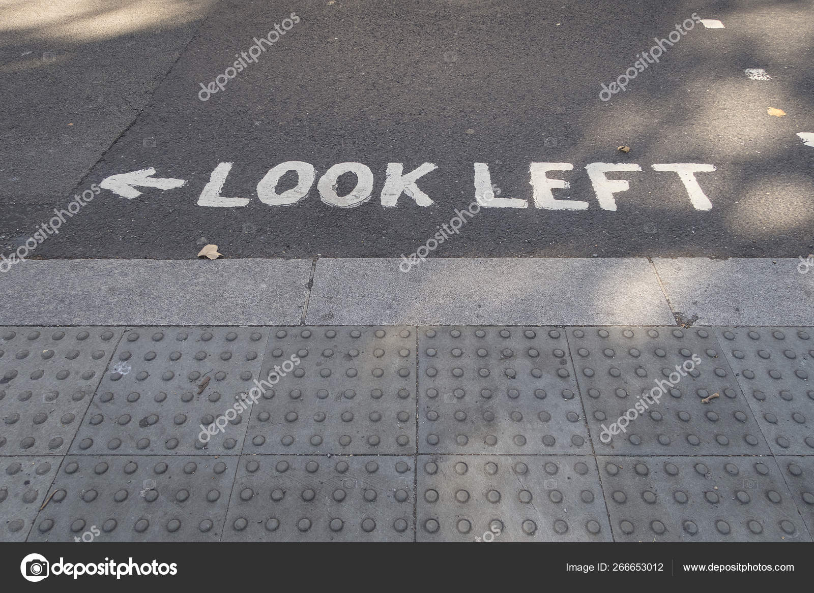 Pedestrian crossing with markings look left on the road to help tourist ...