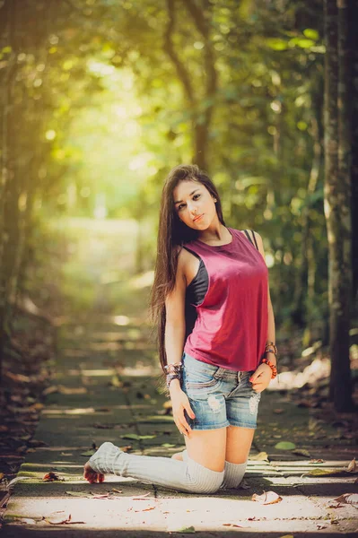 Young Latina model with long hair wearing casual clothes and a ...