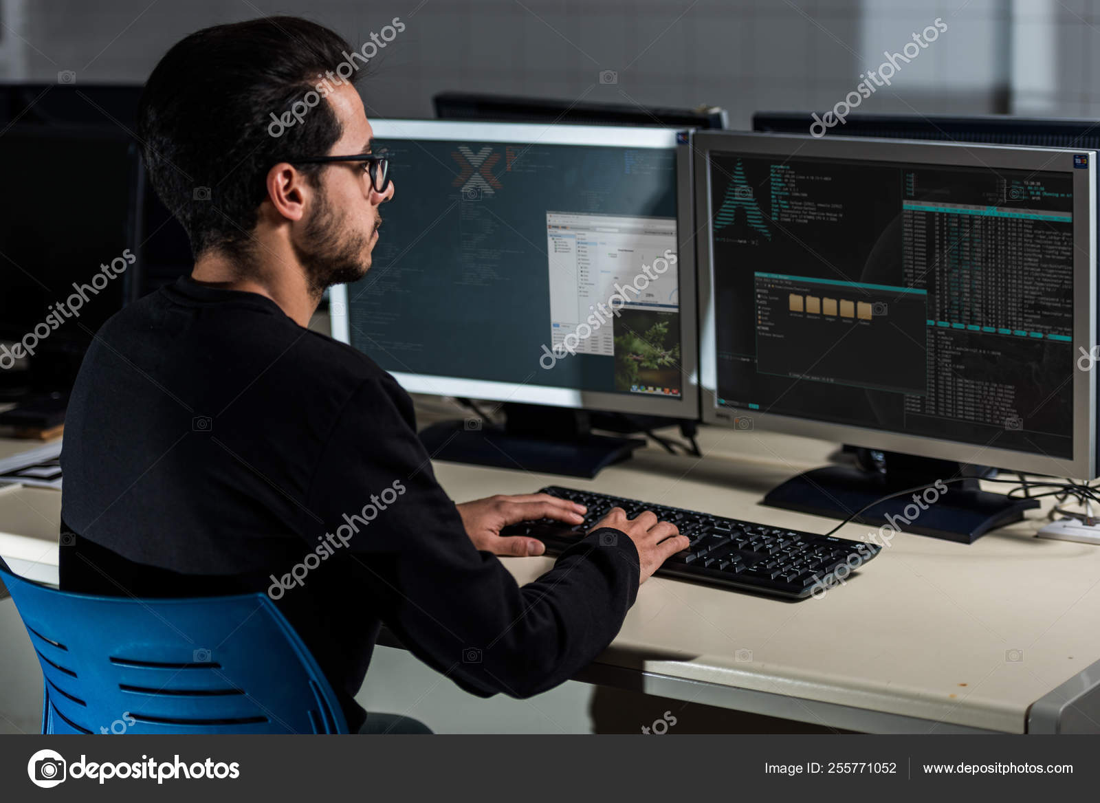 Young computer science student developing with his computer on a Linux ...
