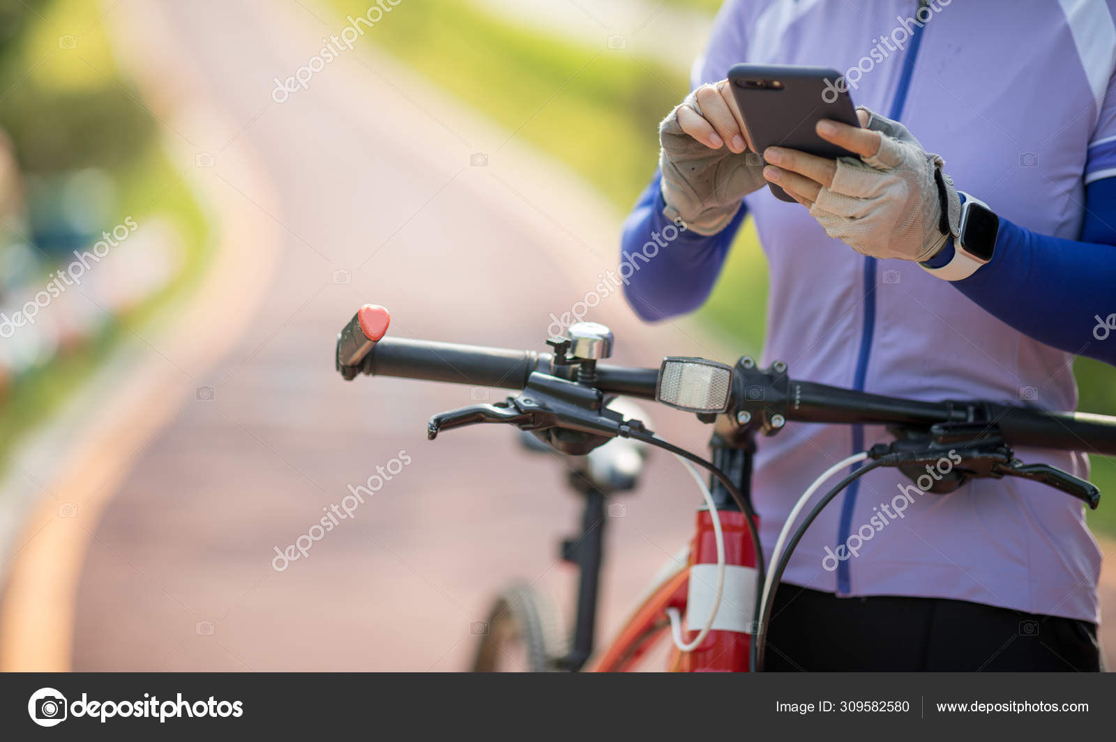 Using Smartphone While Riding Bike Sunny Day — Stock Photo © lzf #309582580