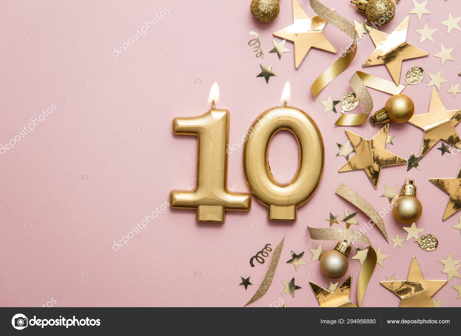 Number 10 gold celebration candle on star and glitter background Stock ...