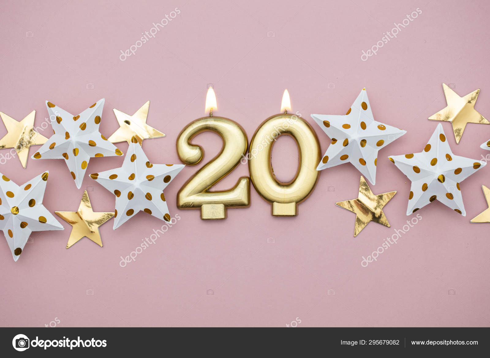 Number 20 gold candle and stars on a pastel pink background Stock Photo ...