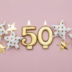 Number 50 gold celebration candle on star and glitter background Stock ...