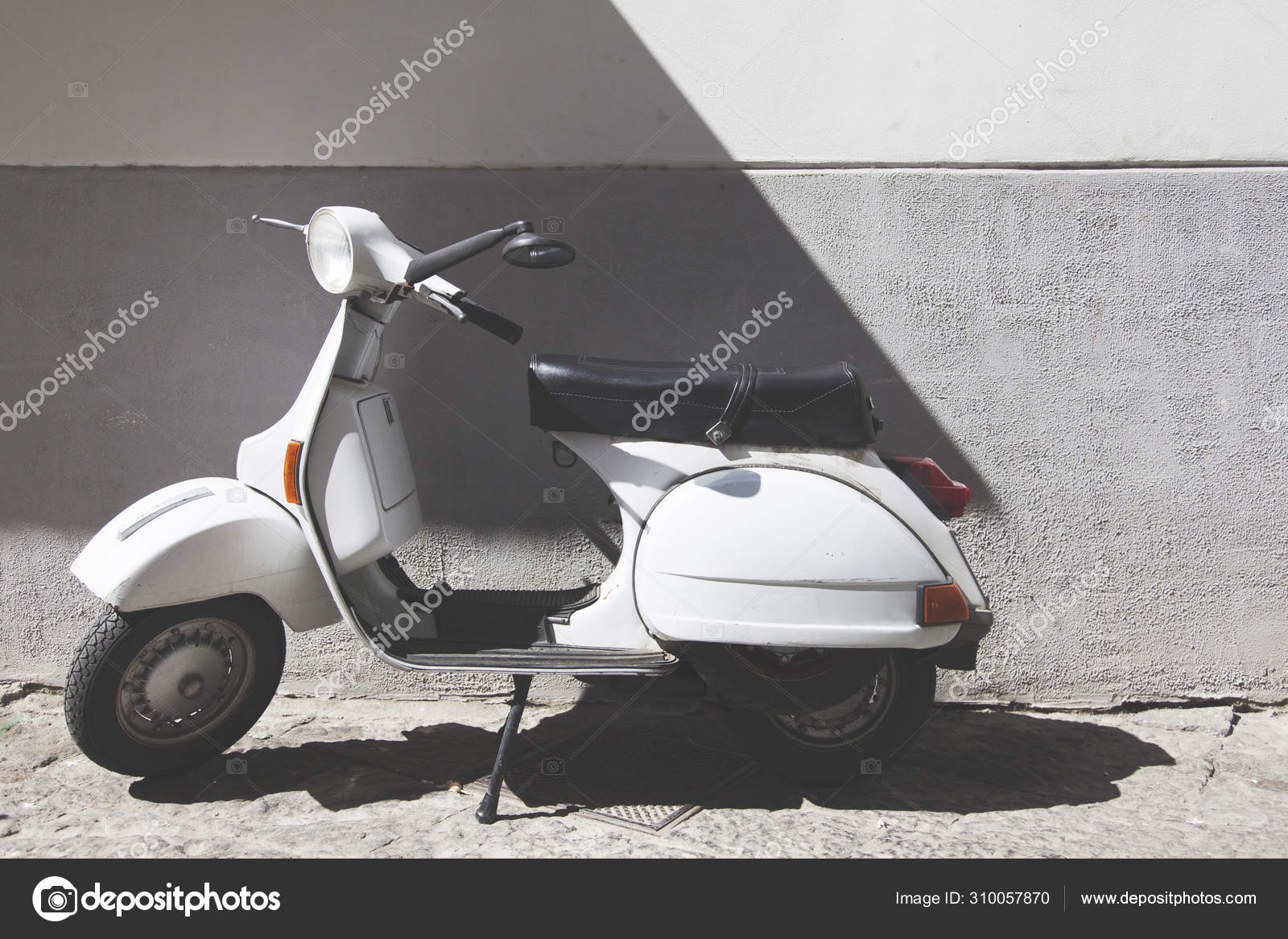 Vintage Italian style moped stands in a street Stock Photo by ...