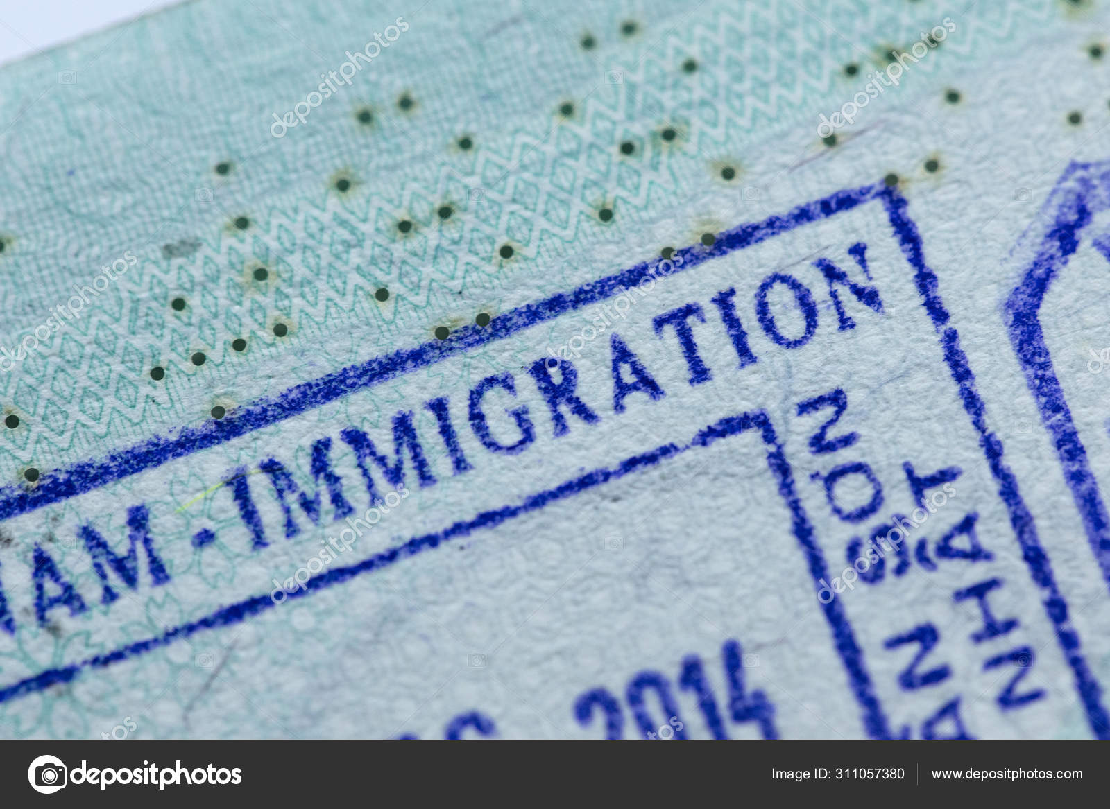 Immigration stamp in a passport — Stock Photo © InkDropCreative #311057380