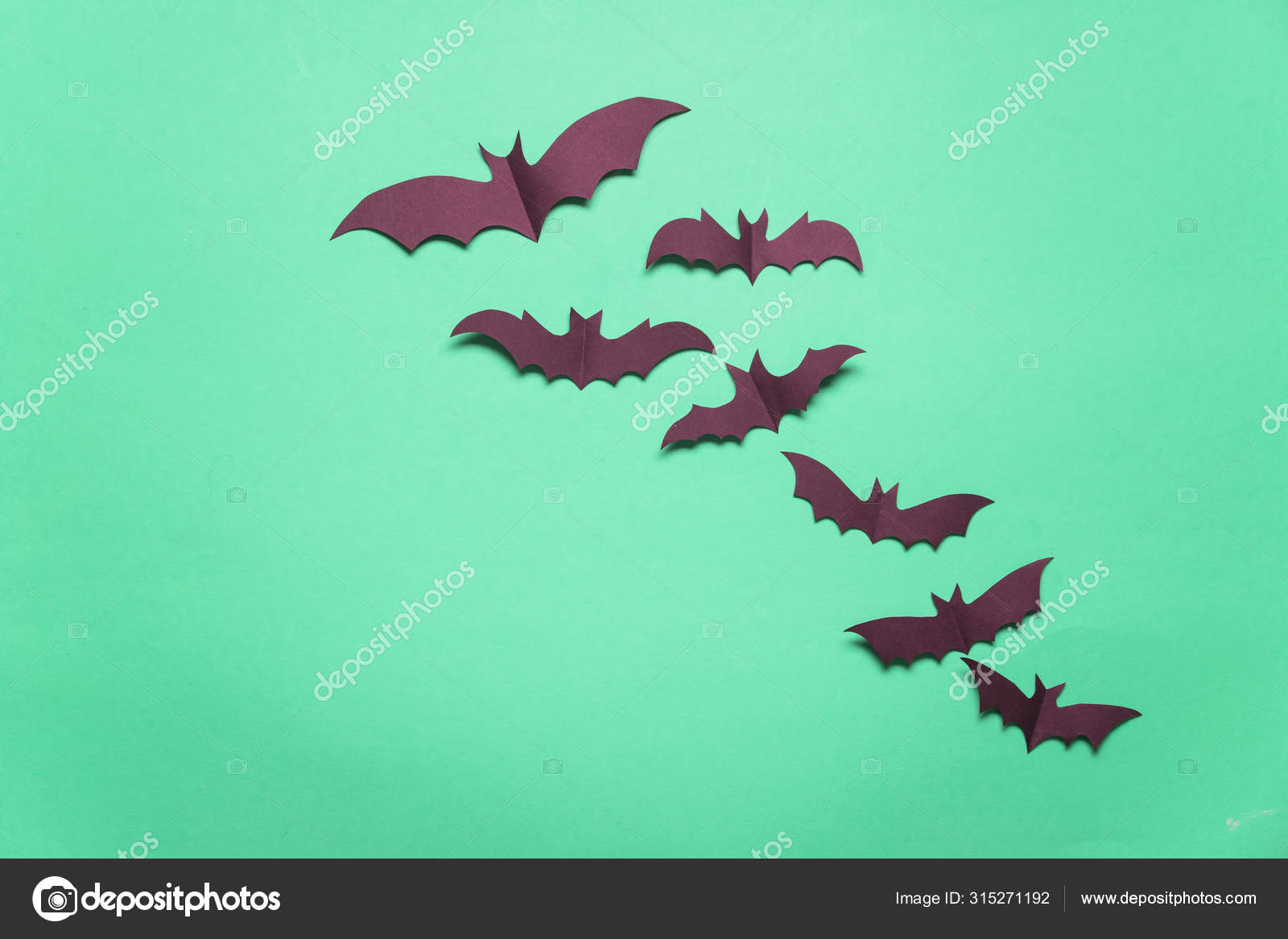 Halloween paper vampire bat decorations on a green background. Stock ...