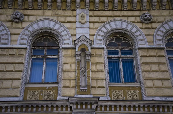 Two windows on a historic historic building with bas-reliefs ...