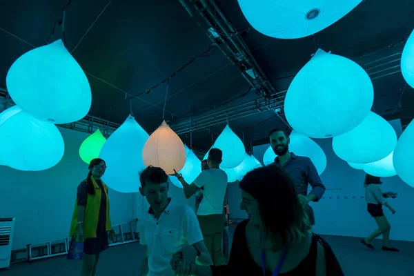 Staff Members Sit Illuminated Giant Raindrop Shaped Installations ...