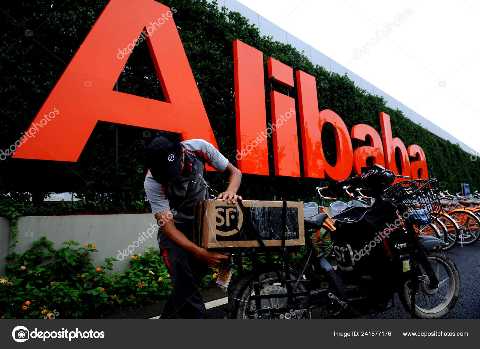 Deliveryman Express Unloads Parcel His Electric Bike Front Logo Alibaba ...