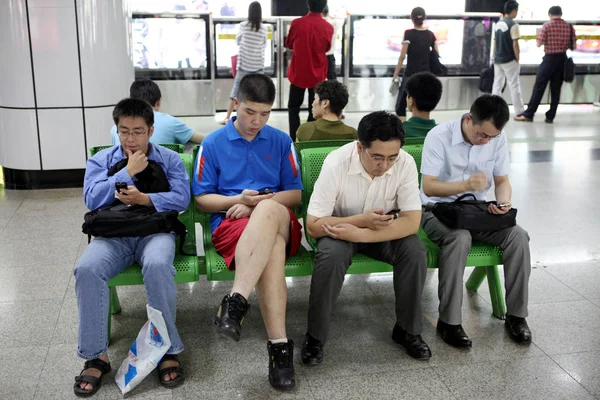 Chinese Passengers Use Mobile Phones While Waiting Metro Trains Subway ...