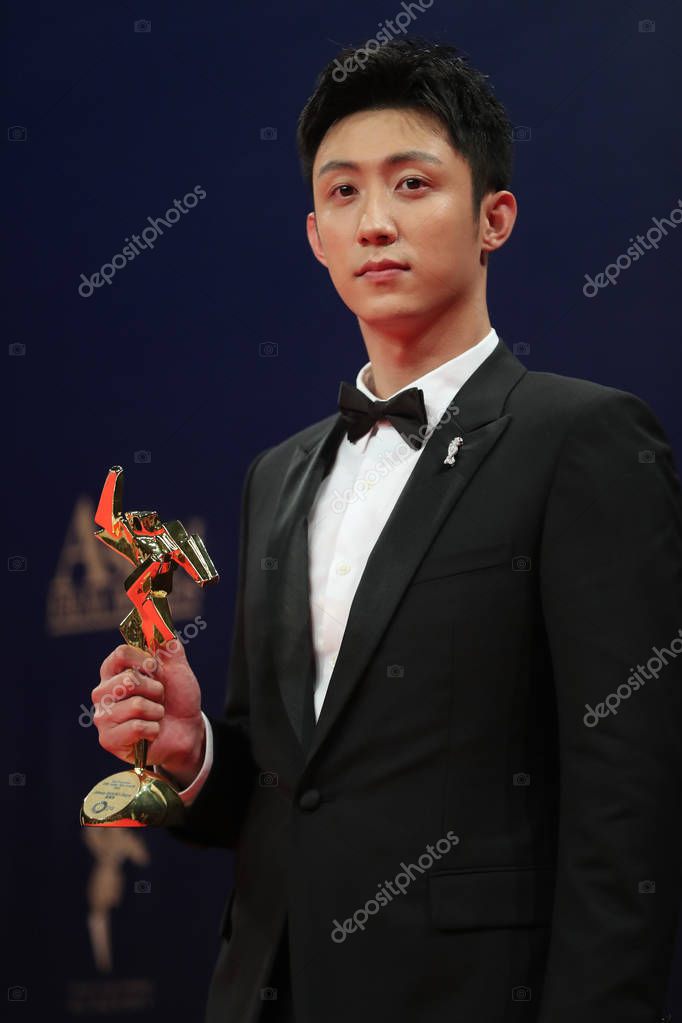 El actor chino Huang Jingyu posa con su trofeo después de ganar el ...