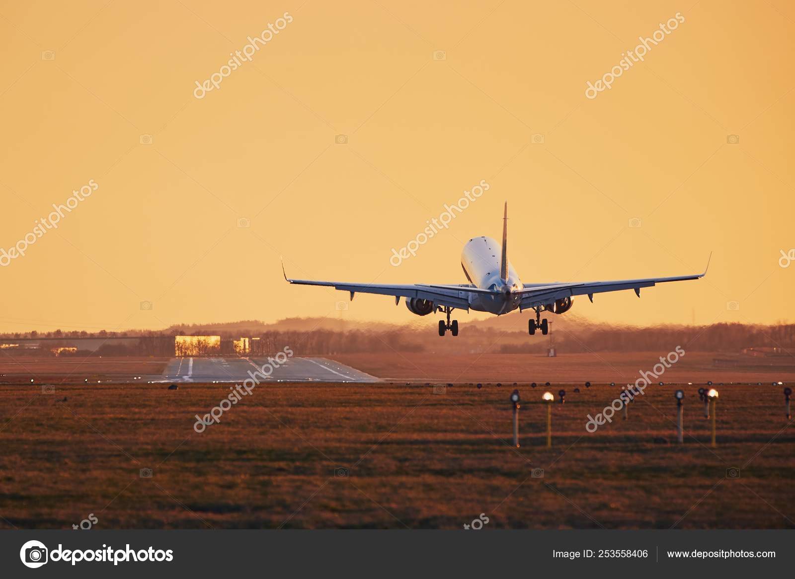 Plane Landing At Sunset