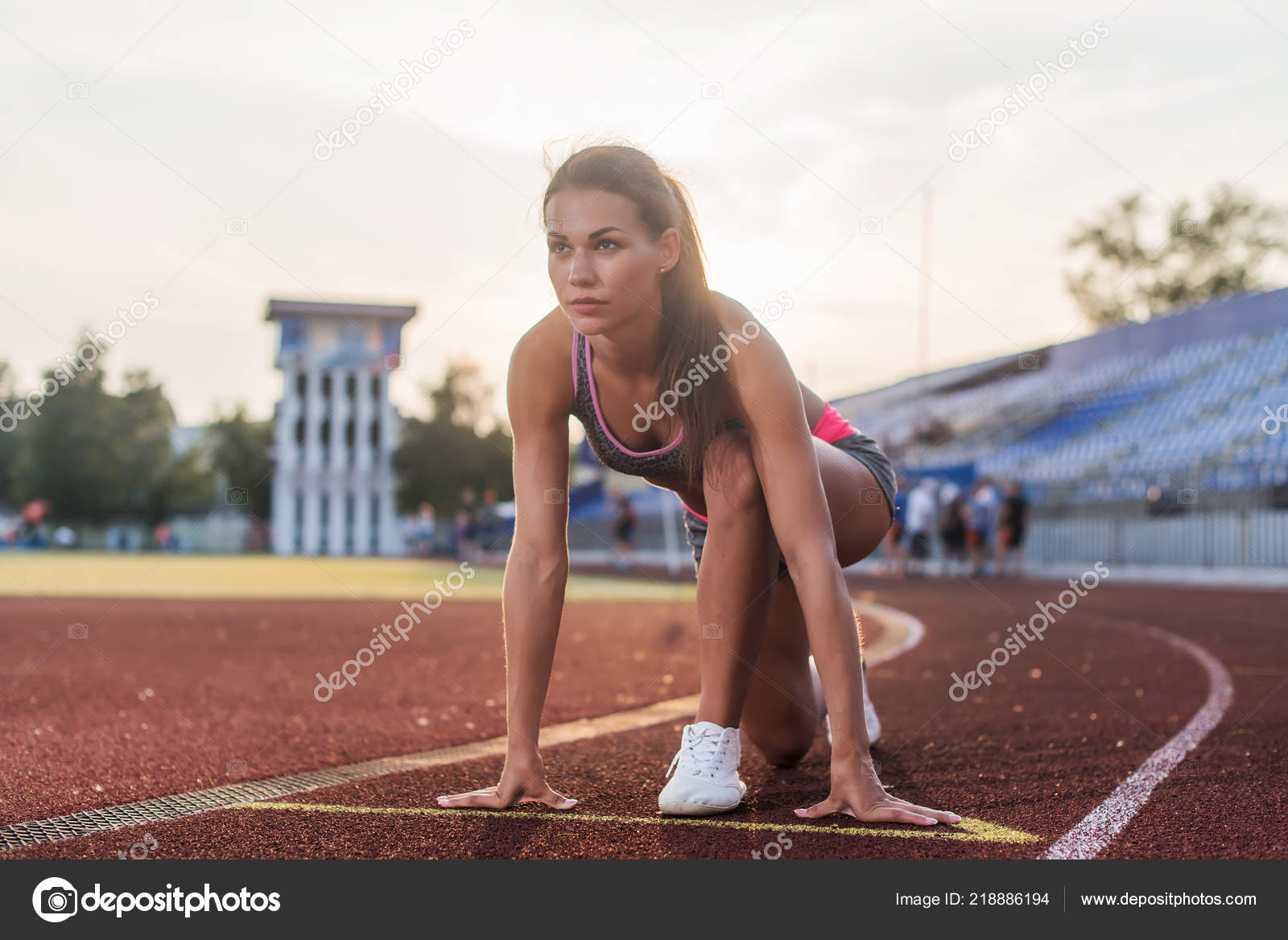 Women Sprinters At Starting Position Ready For Race On Racetrack Stock