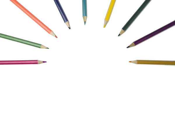 Colored pencils lie in a circle on an isolated white background. Copy ...