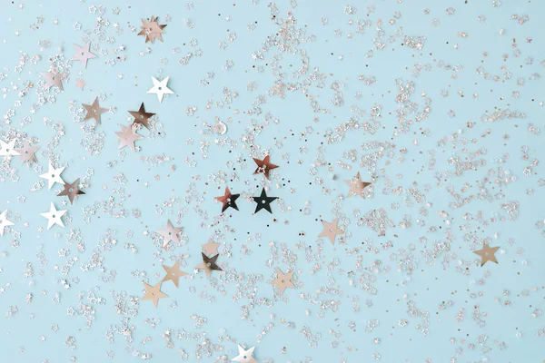 Delicate glitter star confetti on light blue background. Creative and ...
