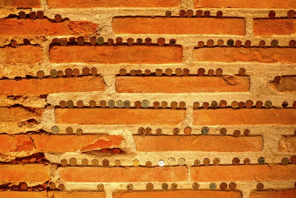 Brick wall background with coins on the bricks closeup view - Stock ...